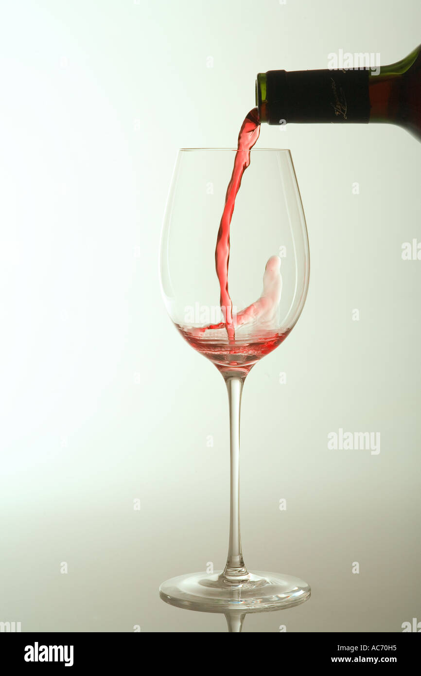 Pouring out glass of a red wine Stock Photo - Alamy