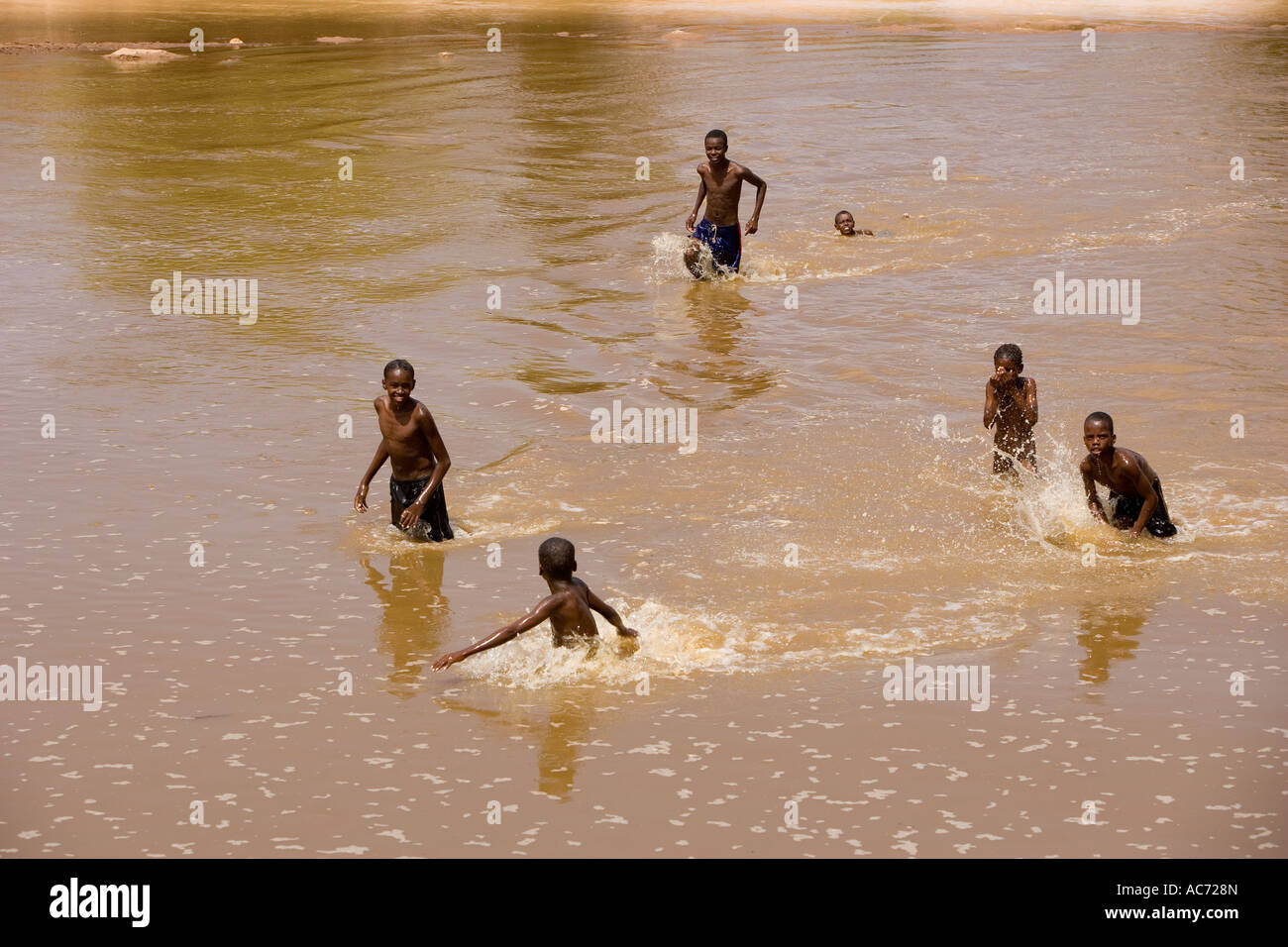 NORTH EAST KENYA Boys play in the waters of a seasonal river that had ...