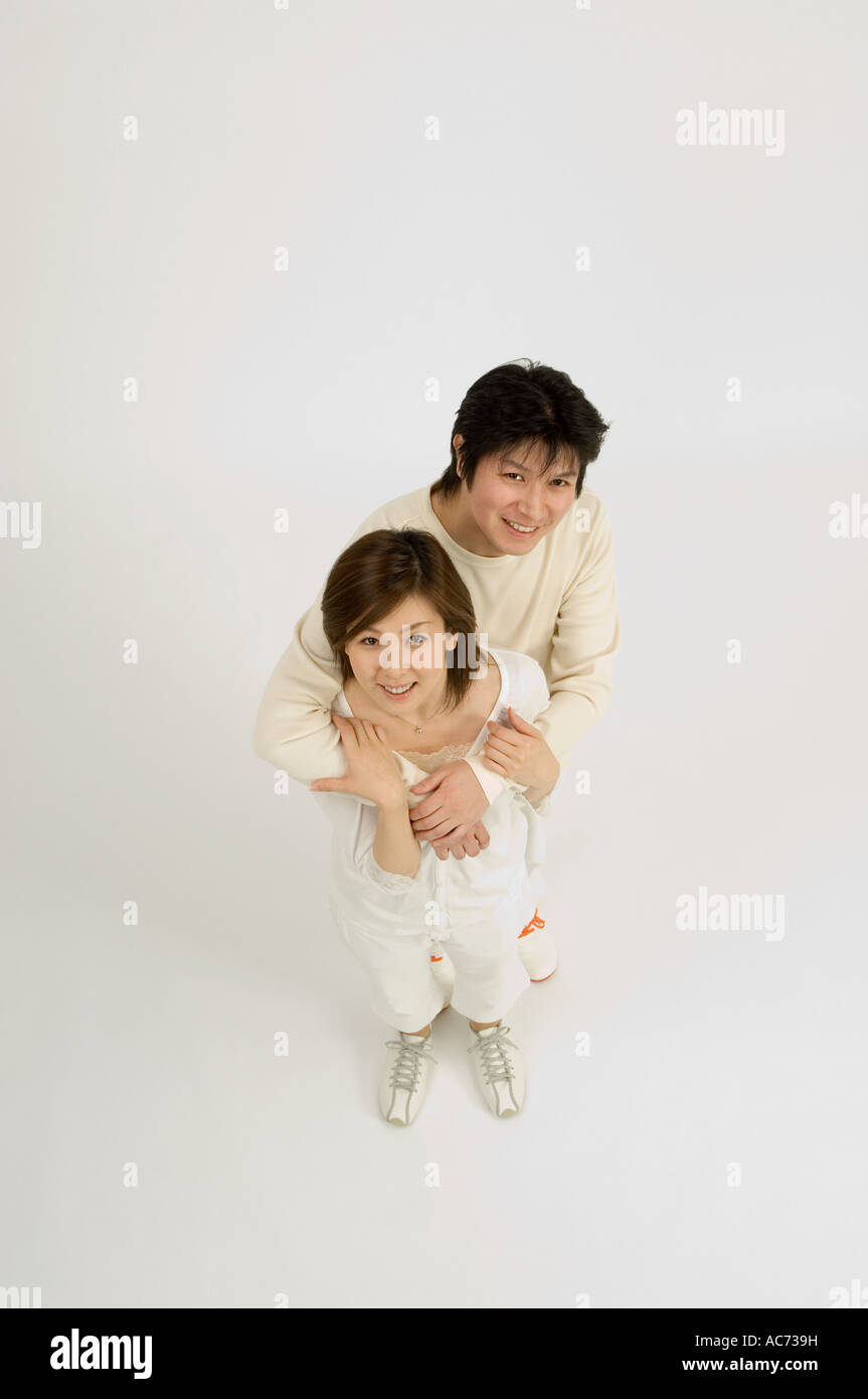 Couple standing looking at camera Stock Photo - Alamy