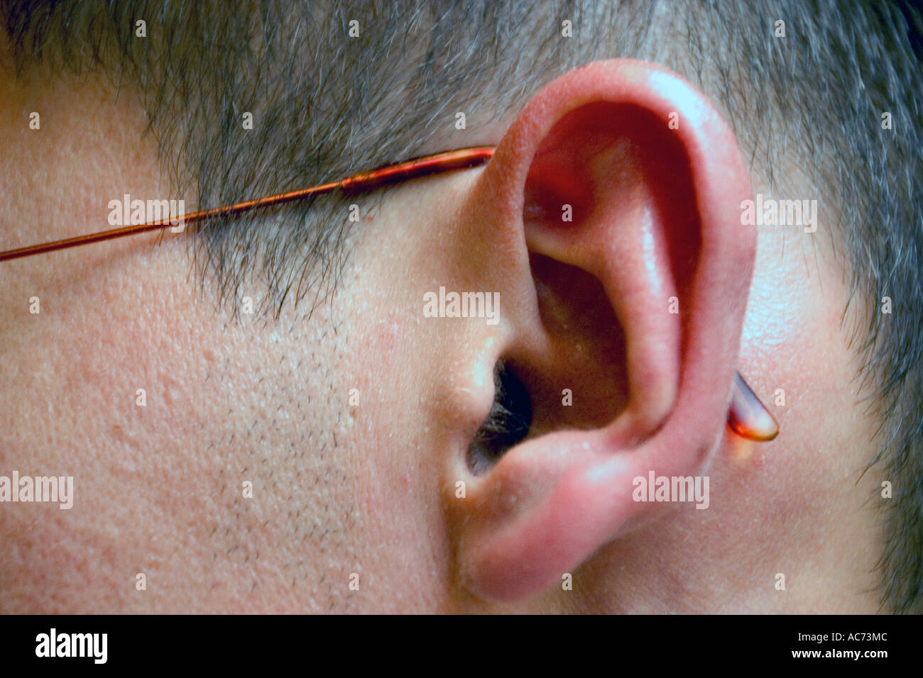 ear of man with glasses Stock Photo - Alamy
