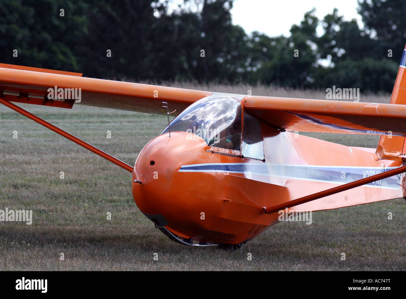 An orange sailplane, glider landing Stock Photo - Alamy