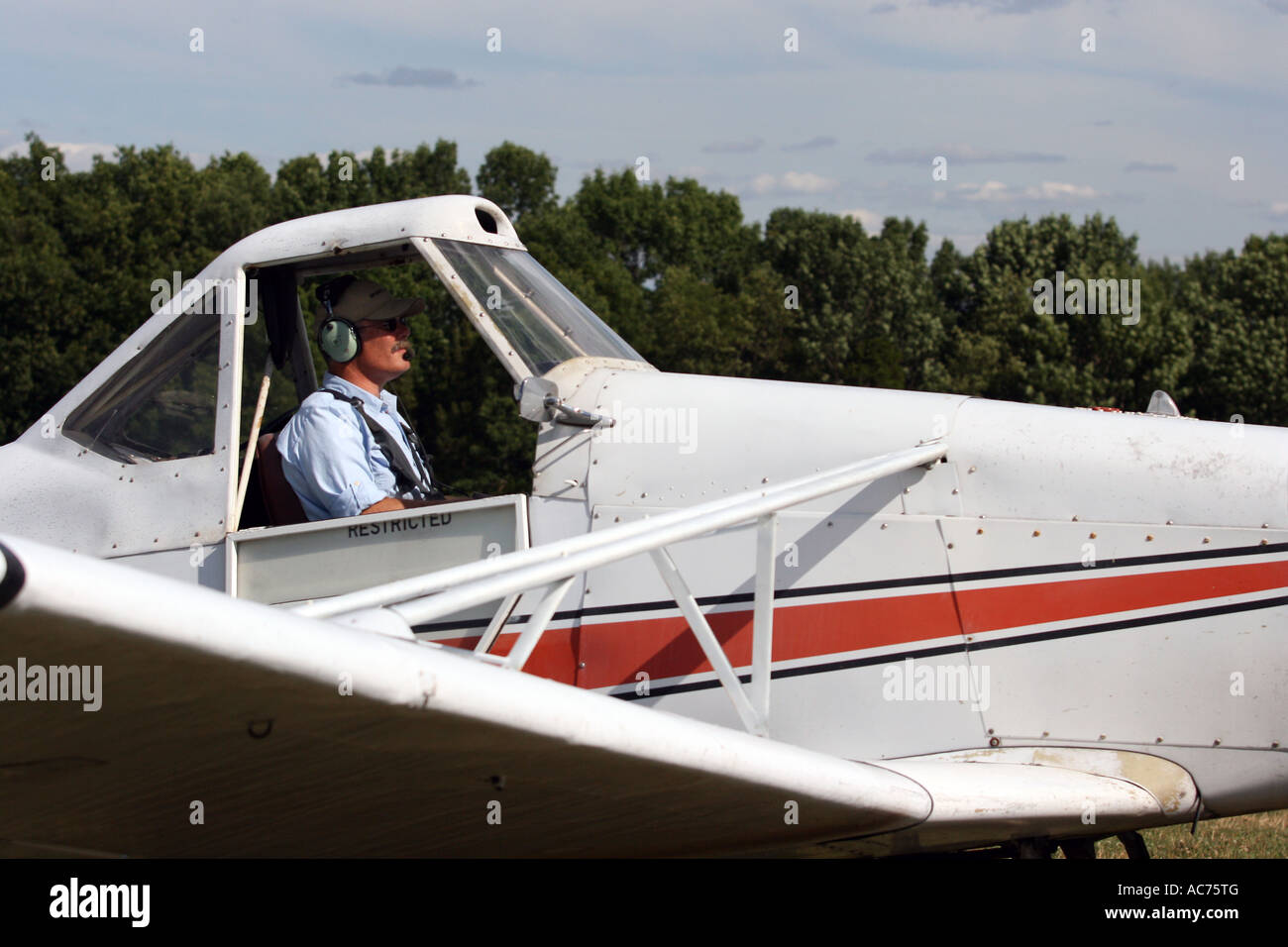 A tow plane pilot waiting in his cockpit Stock Photo - Alamy