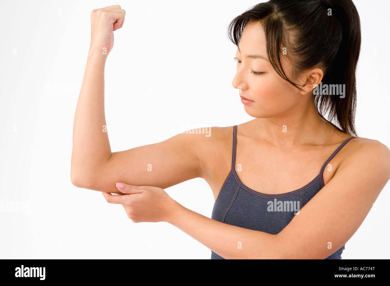 Woman pinching her arm Stock Photo - Alamy