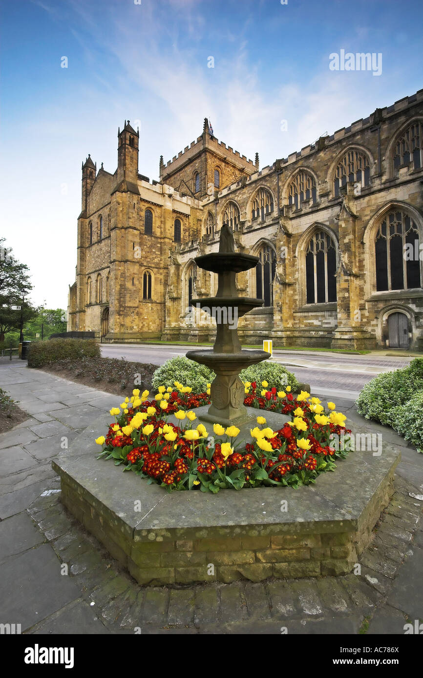 The ornate architecture of Ripon Cathedral and stone water fountain in ...