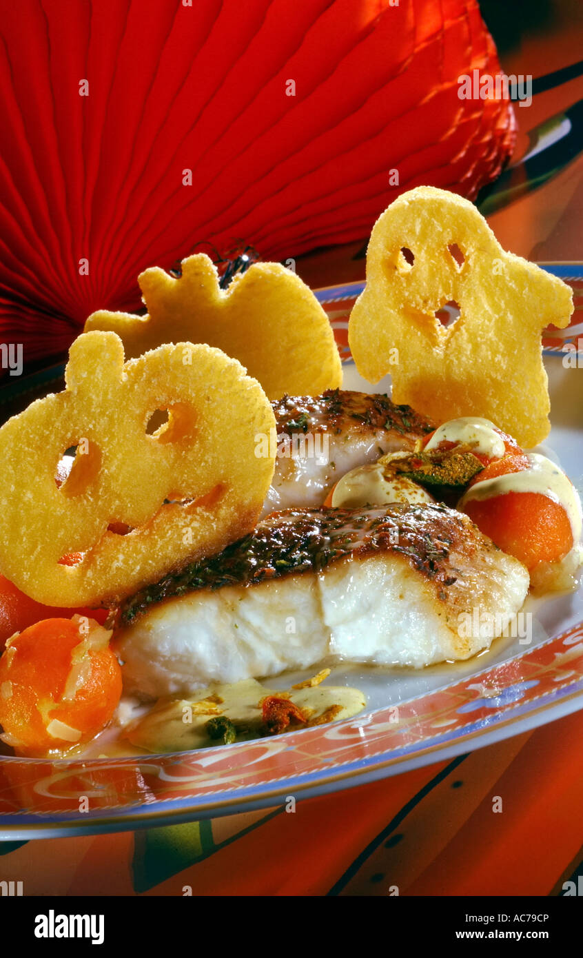 Deep fried potato Halloween decorations on grilled fish meal Stock ...