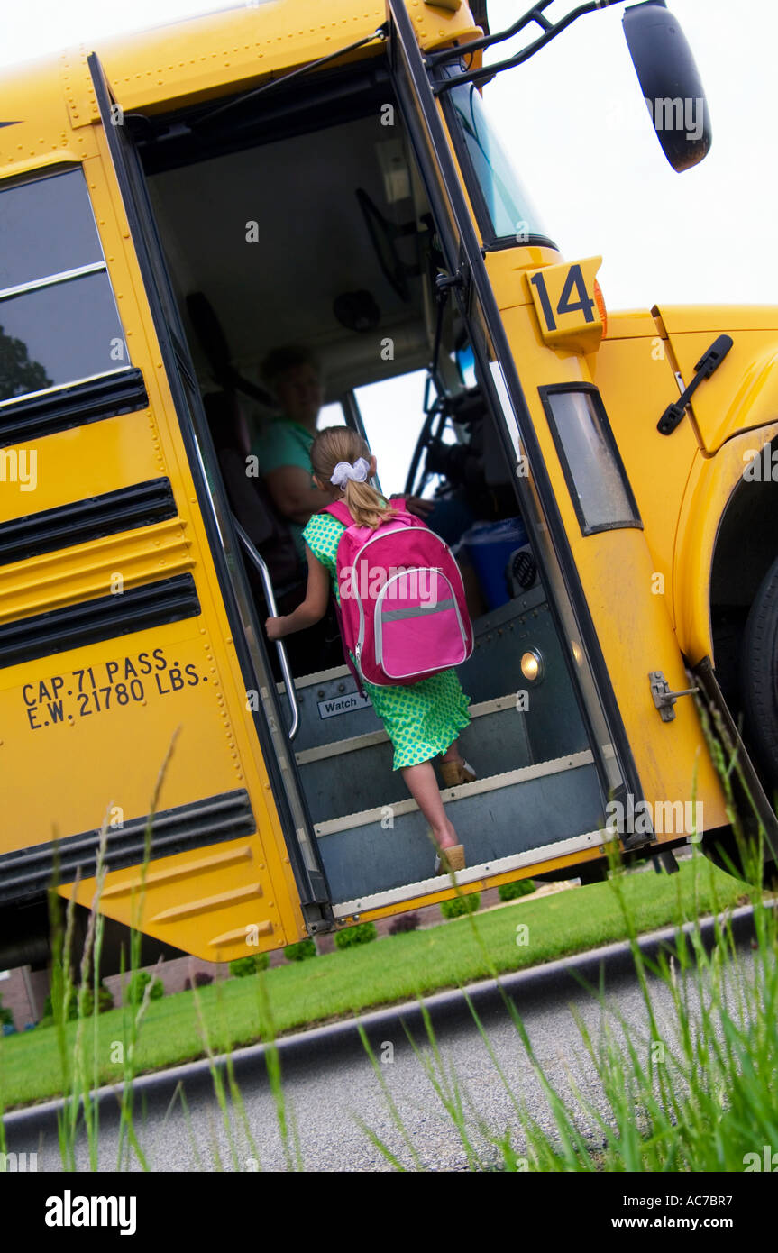 Girl getting on school bus Stock Photo - Alamy