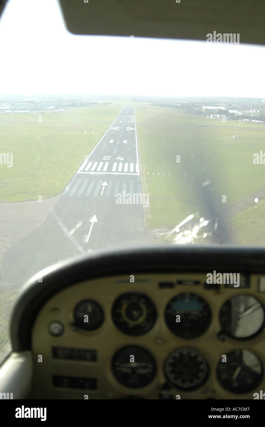 Light aircraft landing runway Stock Photo - Alamy