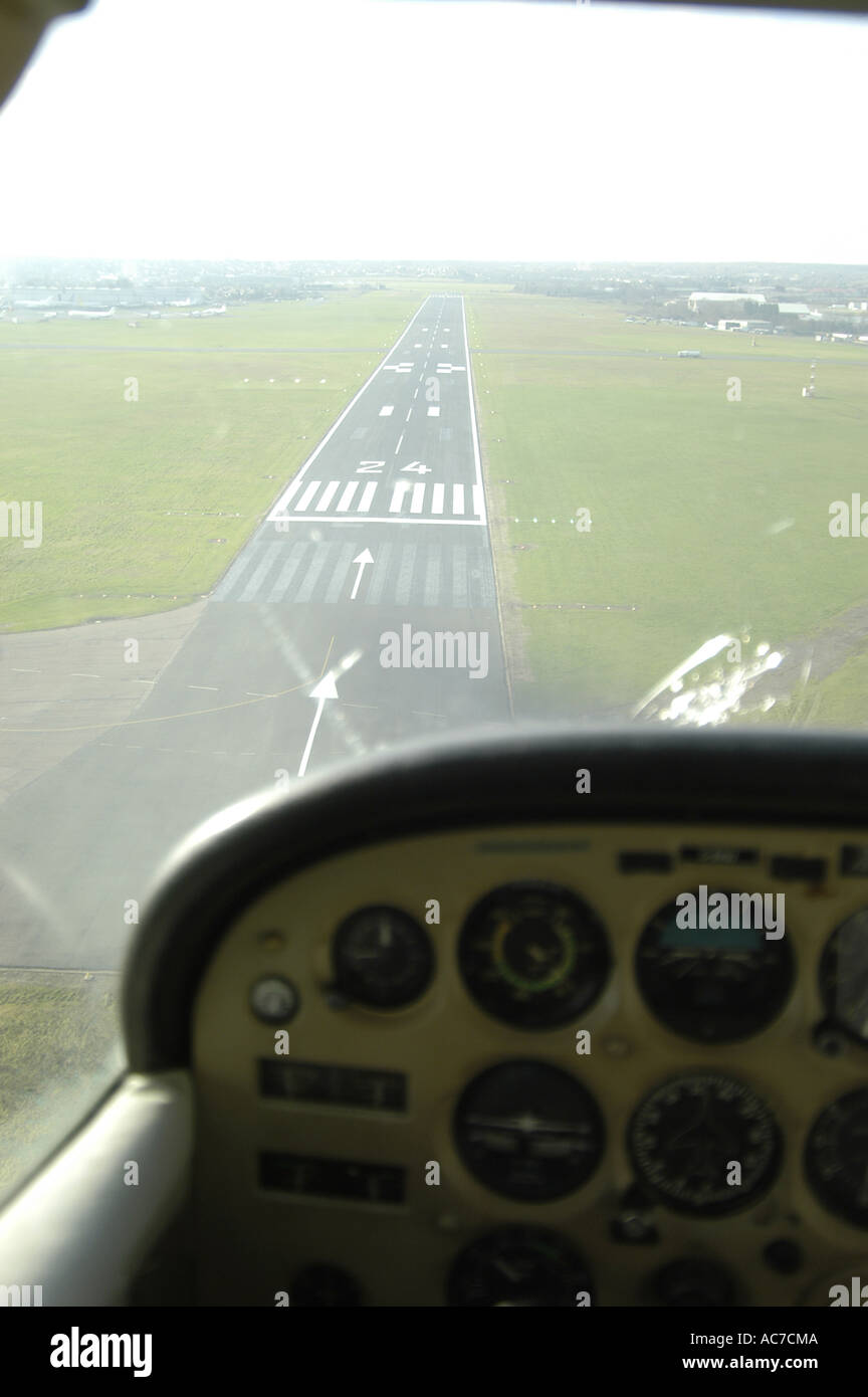 Light aircraft landing runway Stock Photo - Alamy