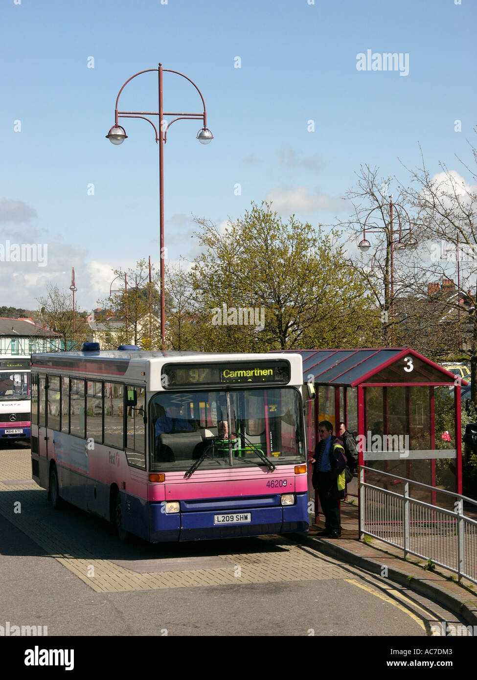 A bus collecting passengers at the bus station in Llanelli Wales UK ...