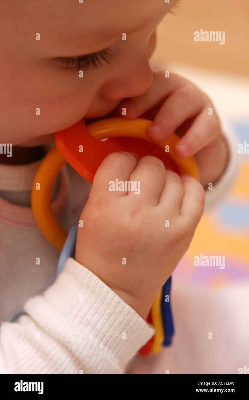 Baby hand holding rattle toy detail hi-res stock photography and images ...