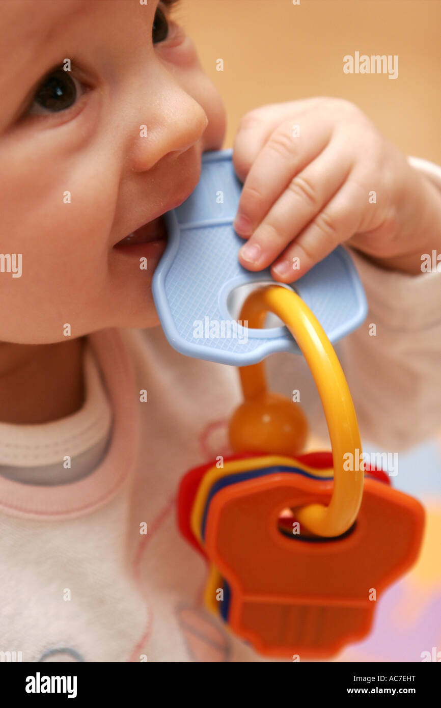 Baby hand holding rattle toy detail hi-res stock photography and images ...