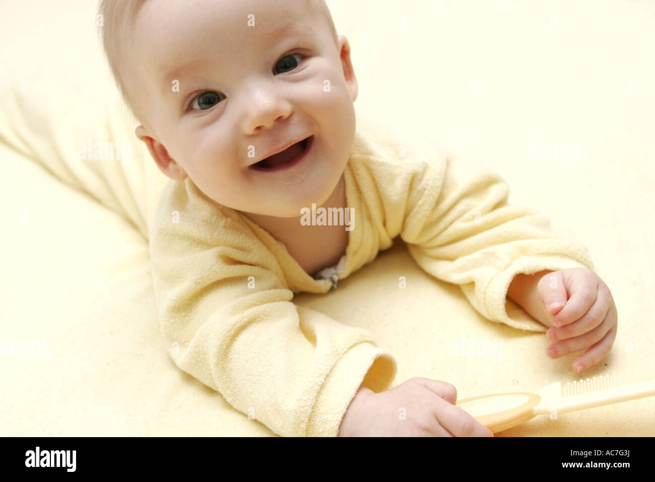 Baby playing with comb Stock Photo - Alamy