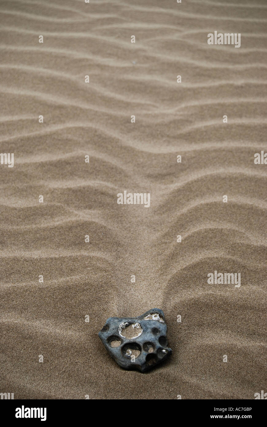 Waves in sand caused by stone Stock Photo - Alamy