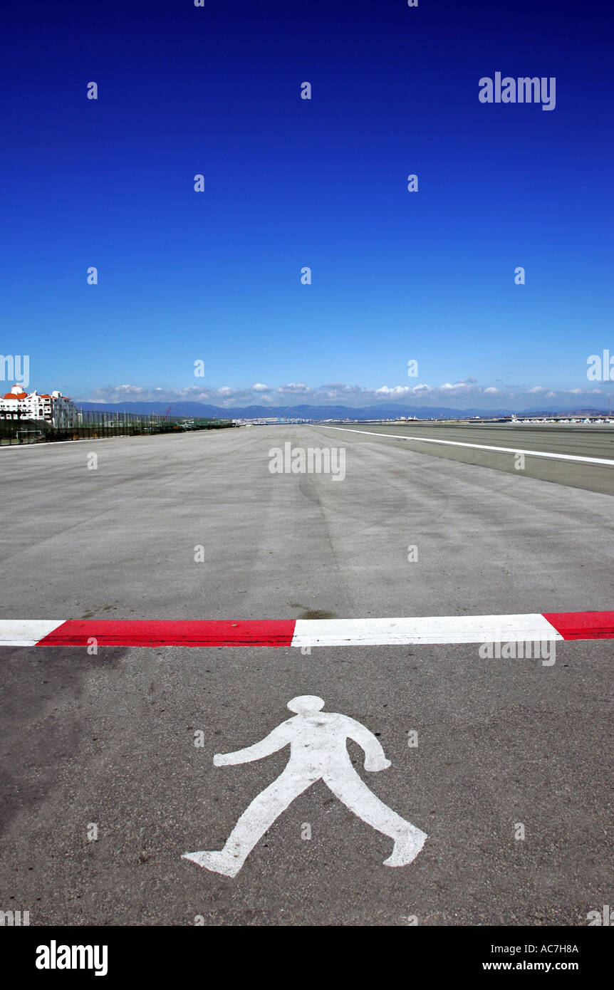 Symbol of walking man on runway at Gibraltar airport with deep rich ...