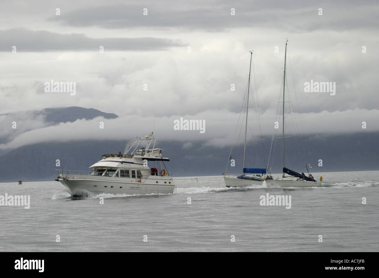 Yachts being towed Stock Photo - Alamy