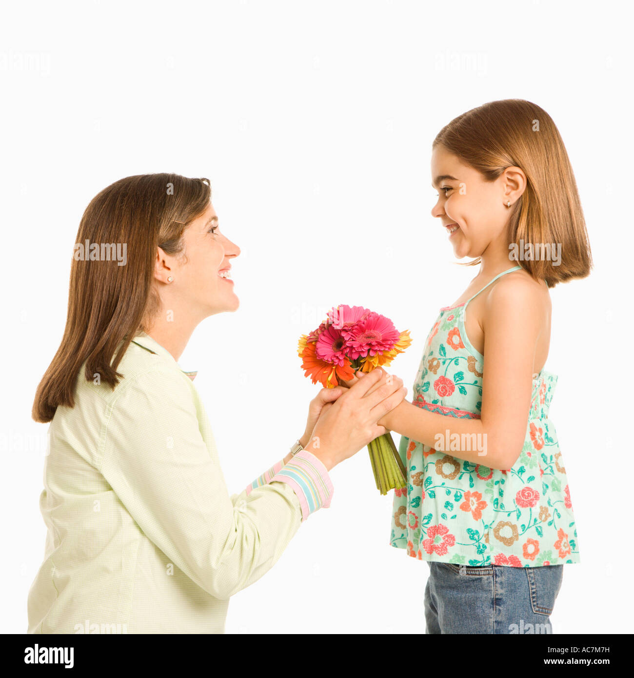 Girl giving bouquet of flowers to mother Stock Photo - Alamy