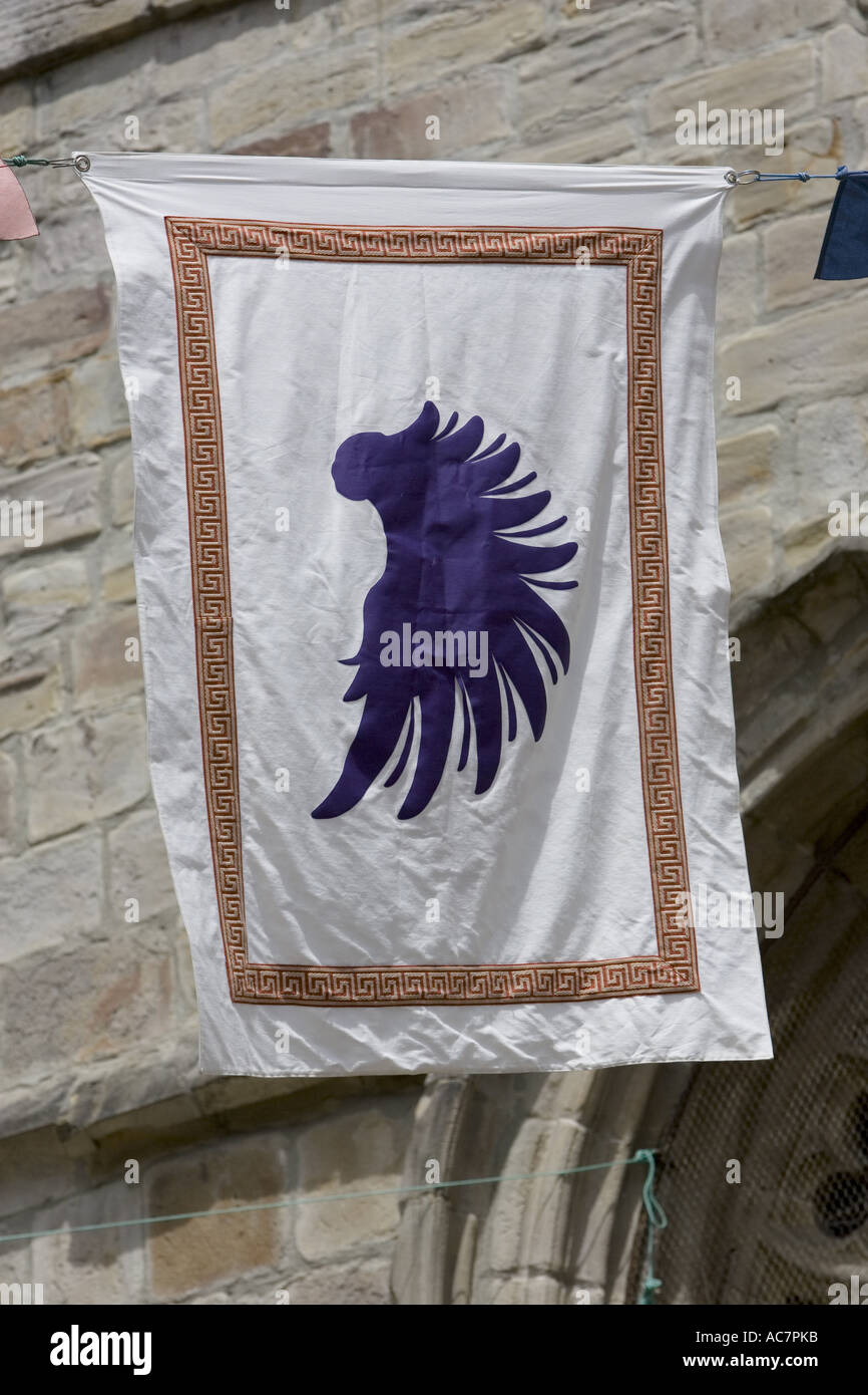 White pennant with purple crest hanging from building during medieval ...
