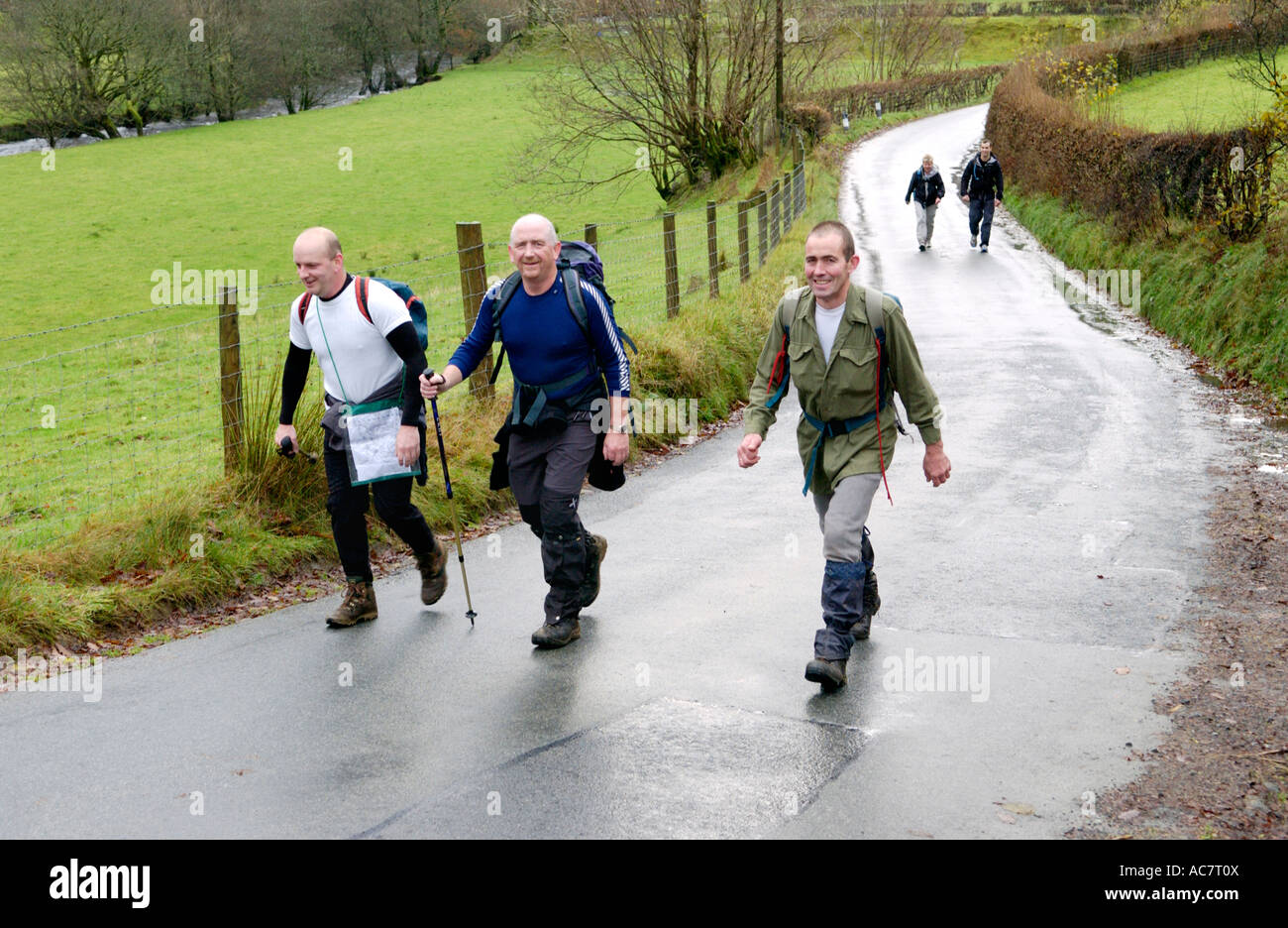 Group of walkers on country road near Llanwrtyd Wells Powys Wales UK ...