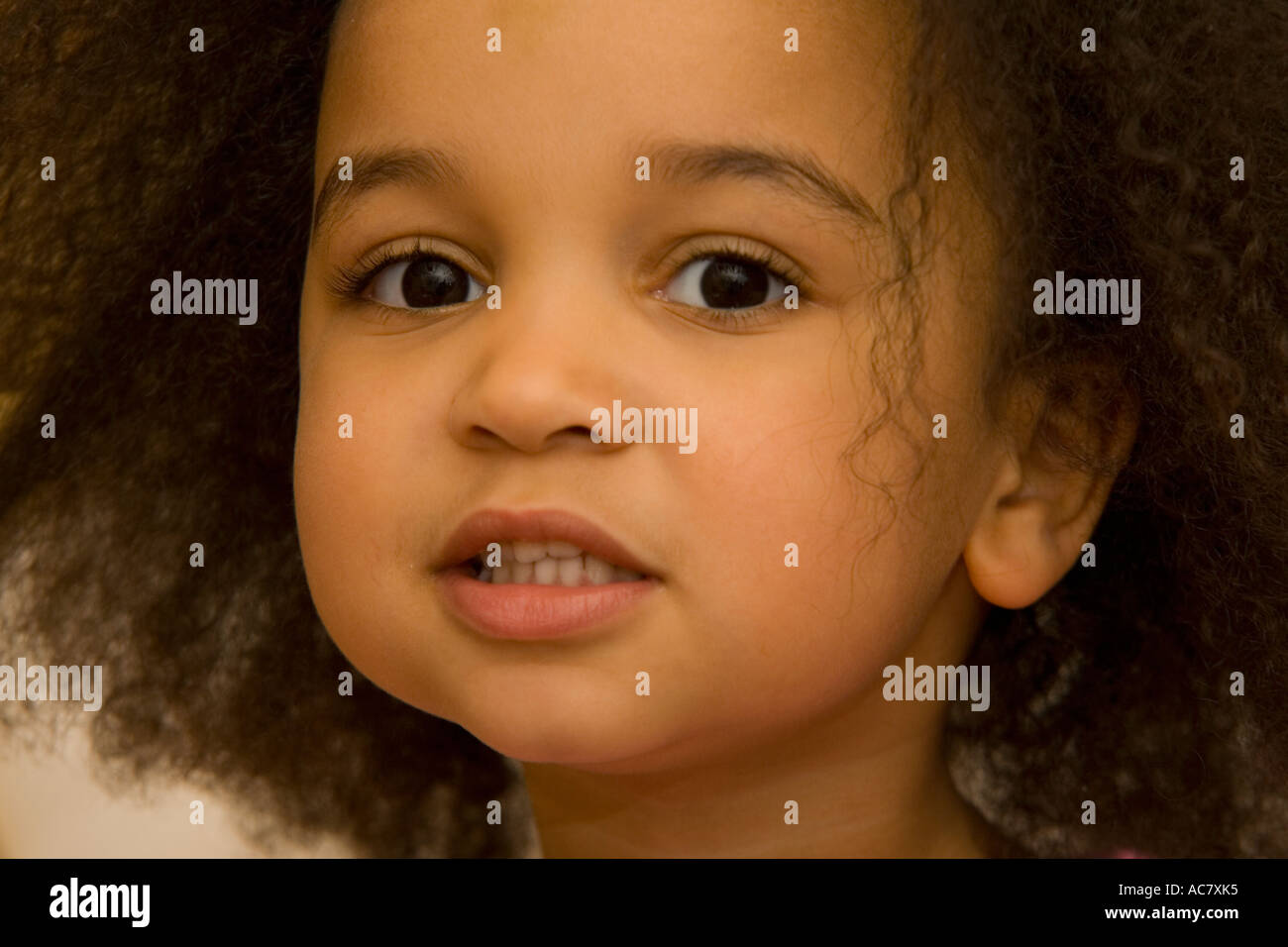 A beautiful mixed race girl with frizzy hair Stock Photo - Alamy