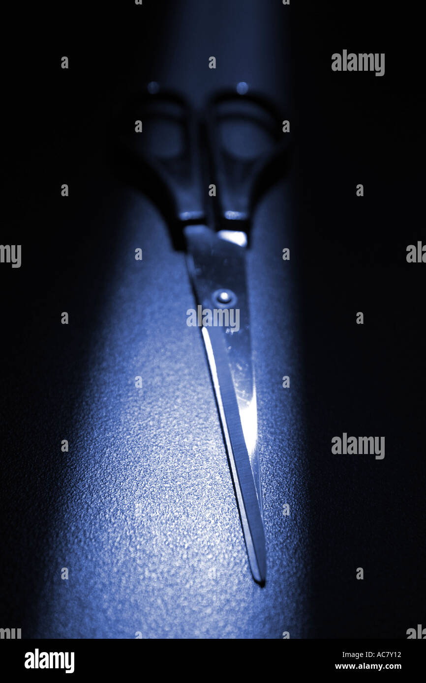 Pair of scissors on black background with spotlight Stock Photo - Alamy