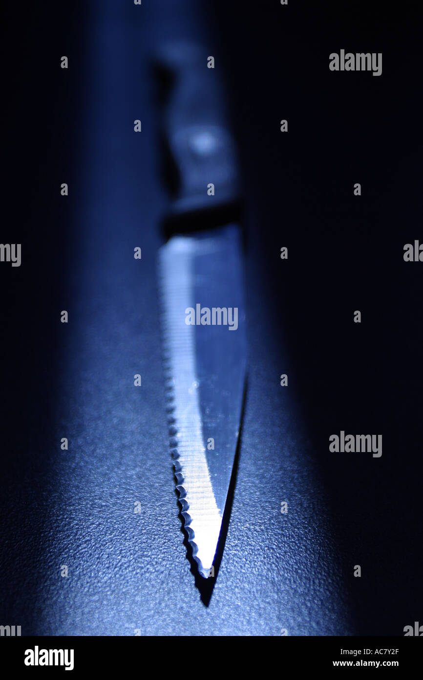 Sharp kitchen knife on black background with blue tint spotlight Stock ...