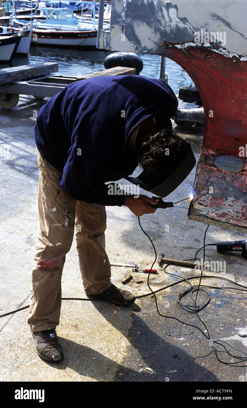 Wielder repairing a fishing boat, Marseille, France Stock Photo - Alamy
