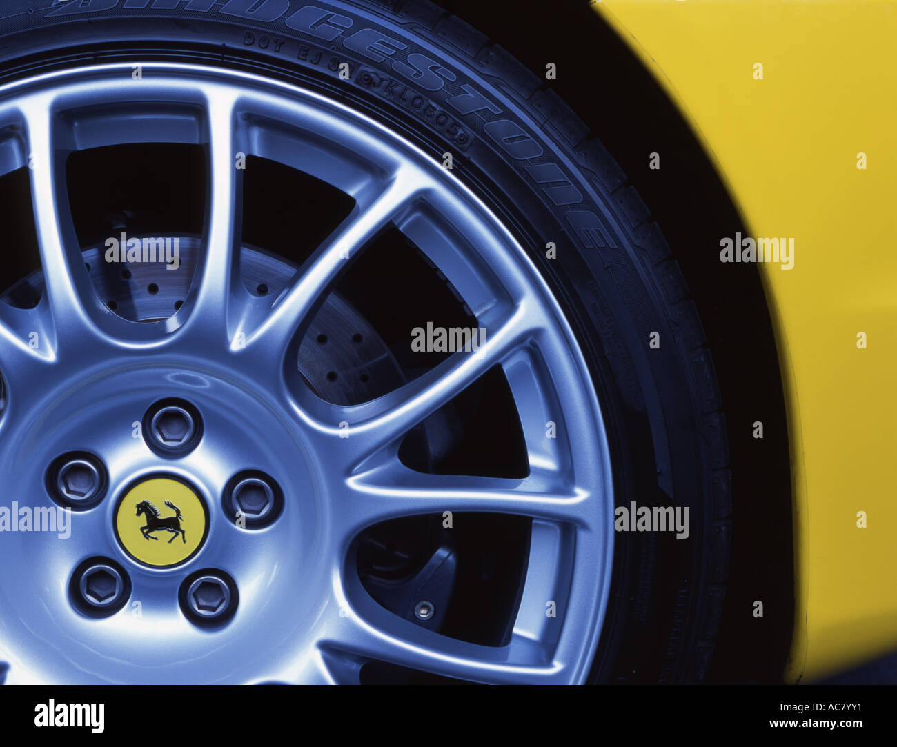 Ferrari wheel and logo on yellow body Stock Photo - Alamy