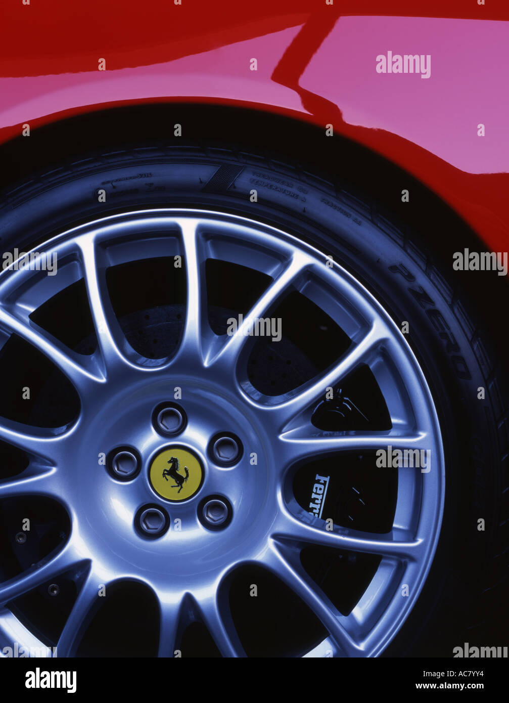 Ferrari wheel and logo on red body Stock Photo - Alamy