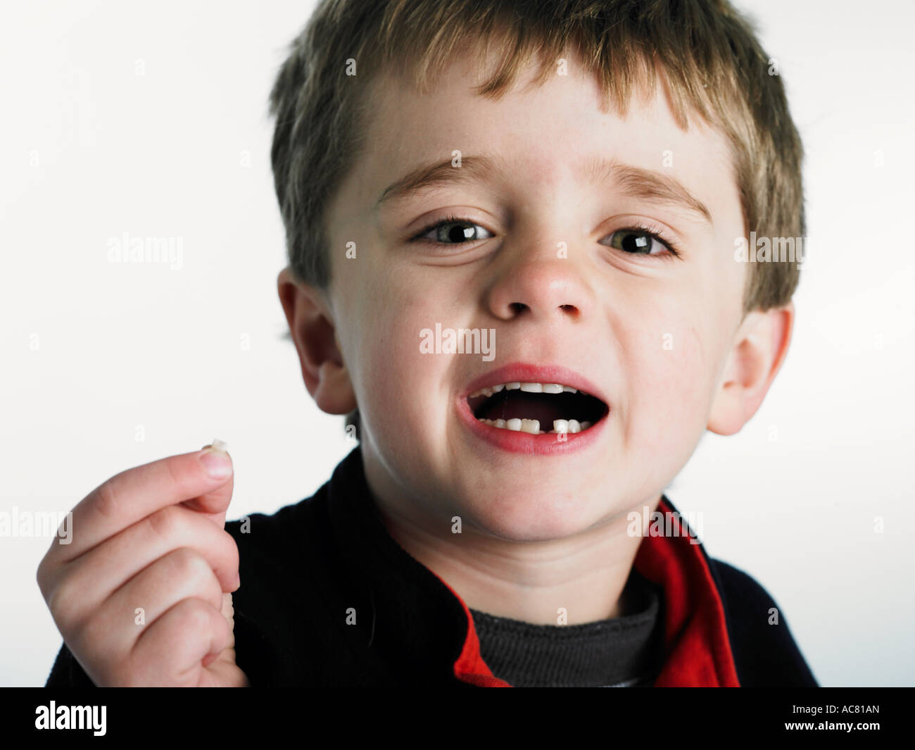 7 year old boy losing tooth Stock Photo - Alamy