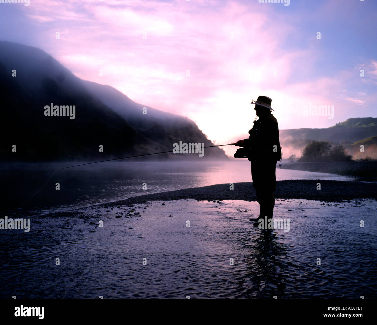 man fly fishing against morning glow tuki tuki river Stock Photo - Alamy
