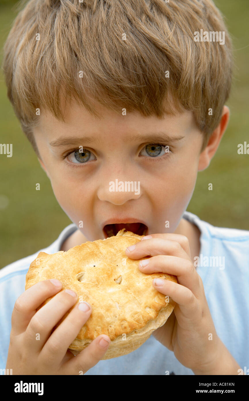 boy 7 eating pie for lunch Stock Photo - Alamy
