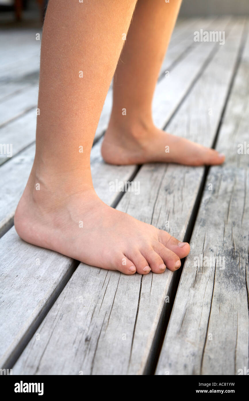 boy 7 standing on deck in bare feet Stock Photo - Alamy