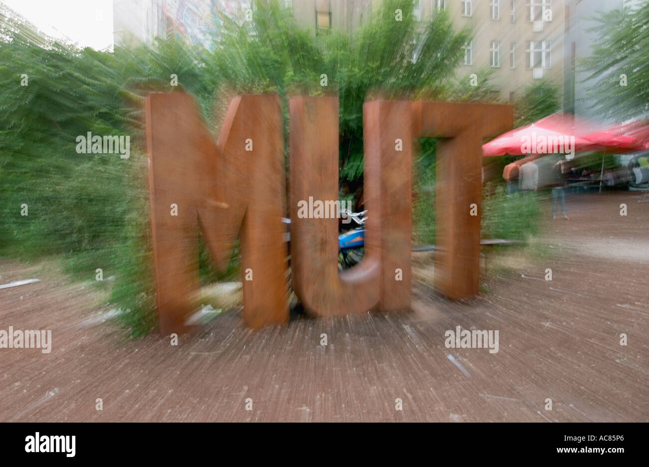 Sculpture of the word MUT Courage in the backyard of alternative art ...