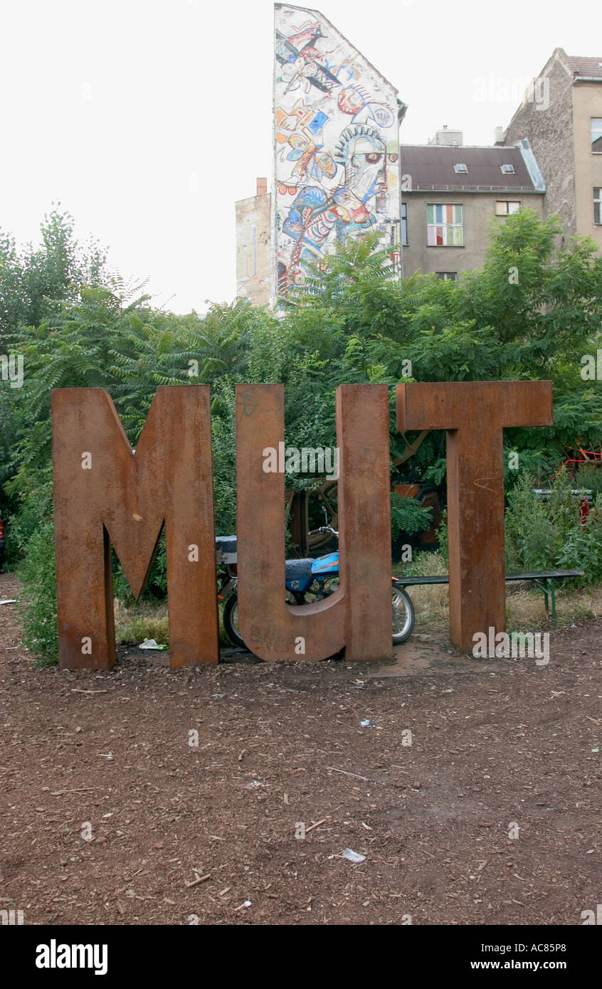 Sculpture of the word MUT Courage in the backyard of alternative art ...