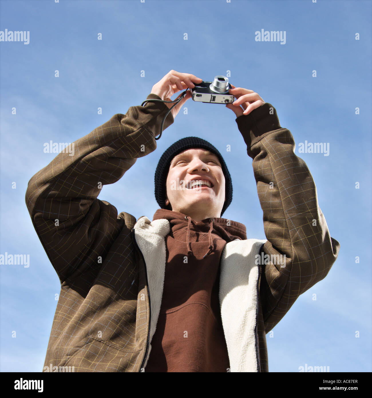 Caucasian male teenager taking a picture with a digital camera Stock ...