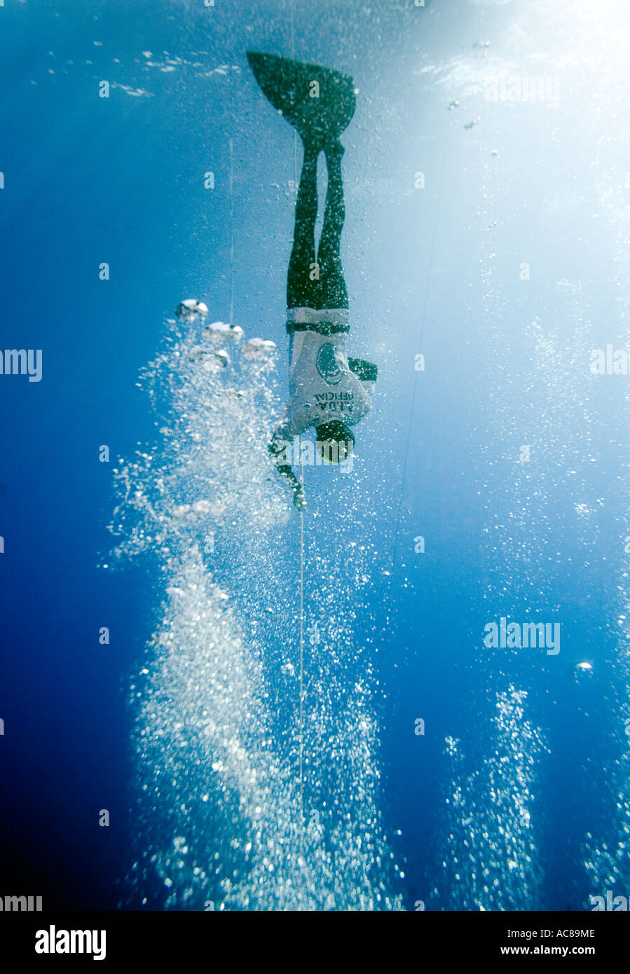 Free Diver passes through technical divers bubbles Stock Photo - Alamy