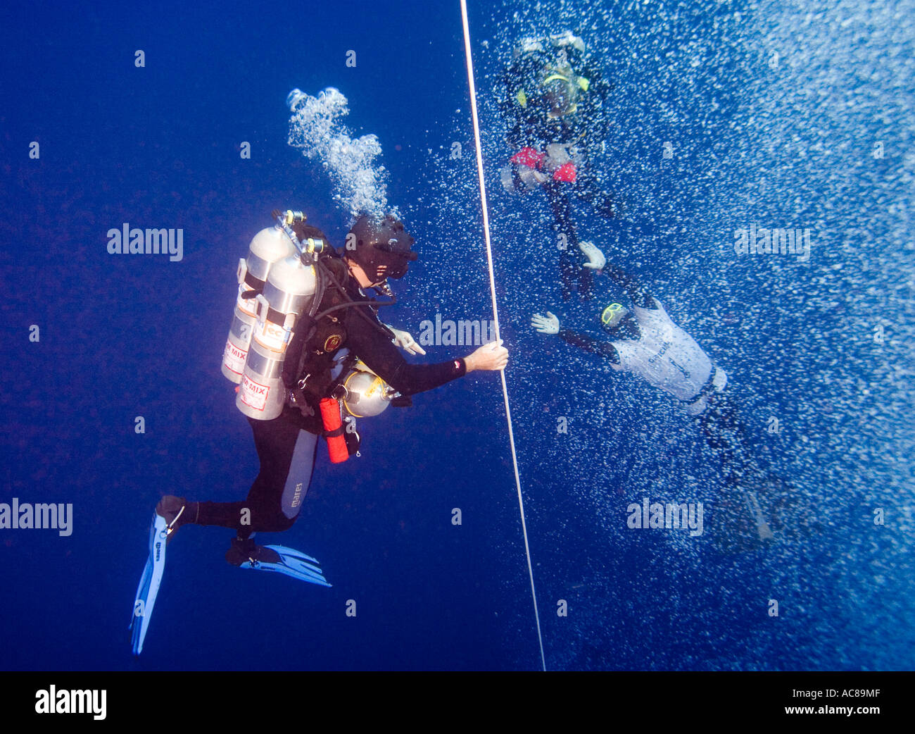 Free Diver passes through technical divers bubbles Stock Photo - Alamy