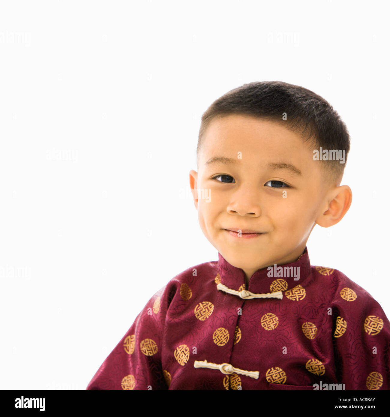 Asian boy standing against white background in traditional attire Stock ...