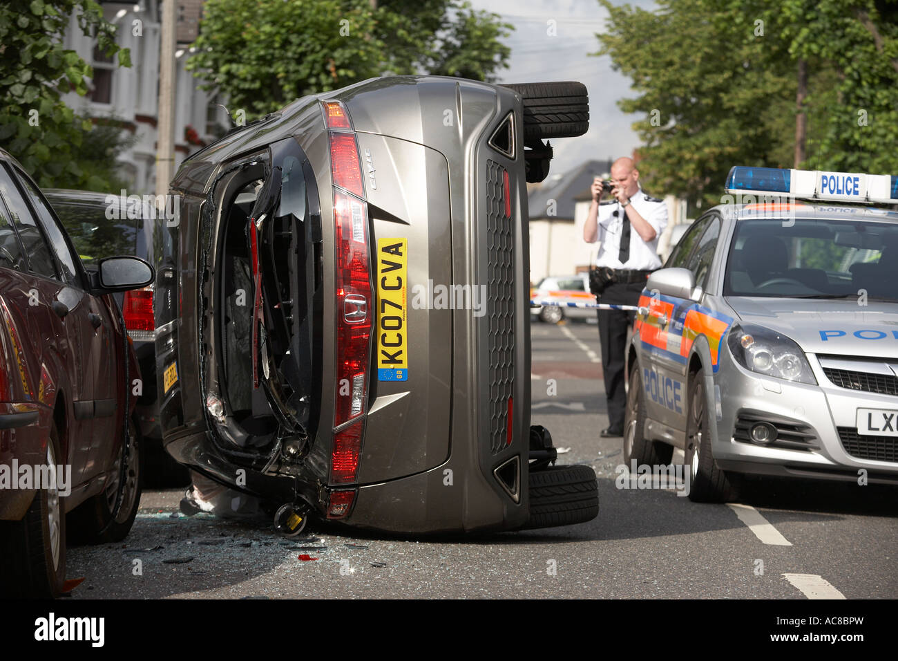 A police officer photographs evidence after a high-speed pursuit in a ...