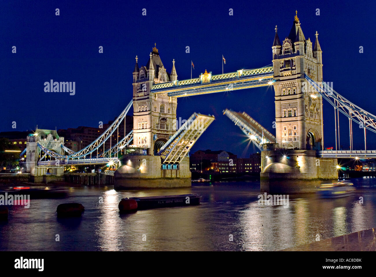 Tower Bridge opening at night Stock Photo - Alamy