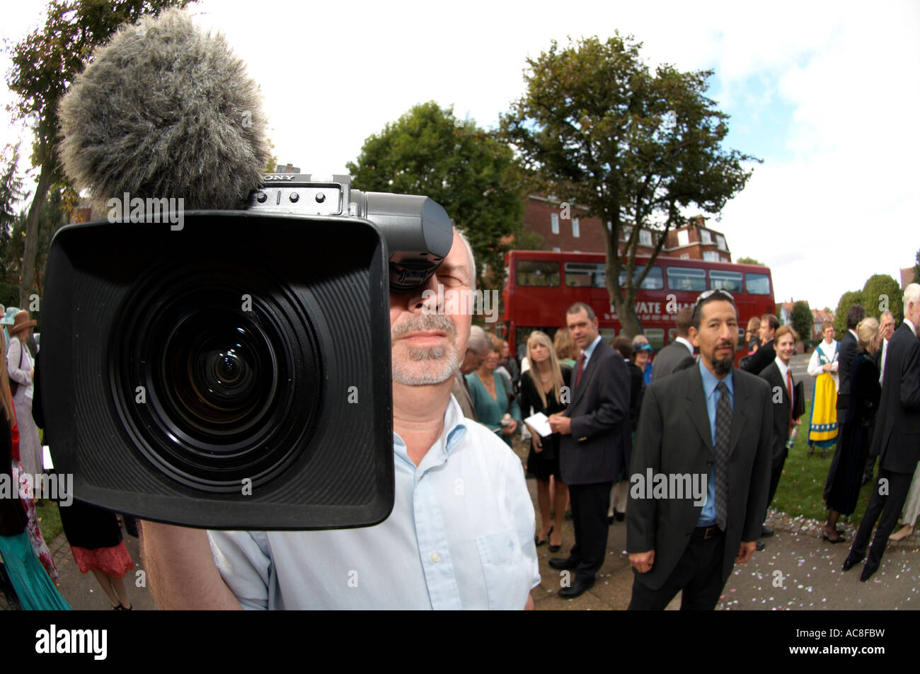 Cameraman shooting a wedding in the UK Stock Photo - Alamy