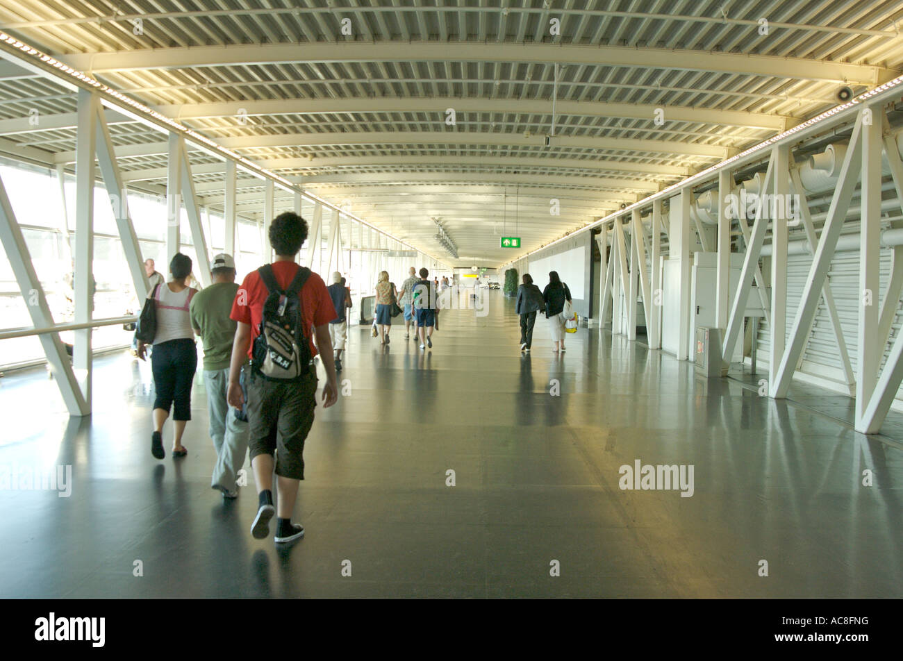 Passengers walking down airport corridor to gate Stock Photo - Alamy