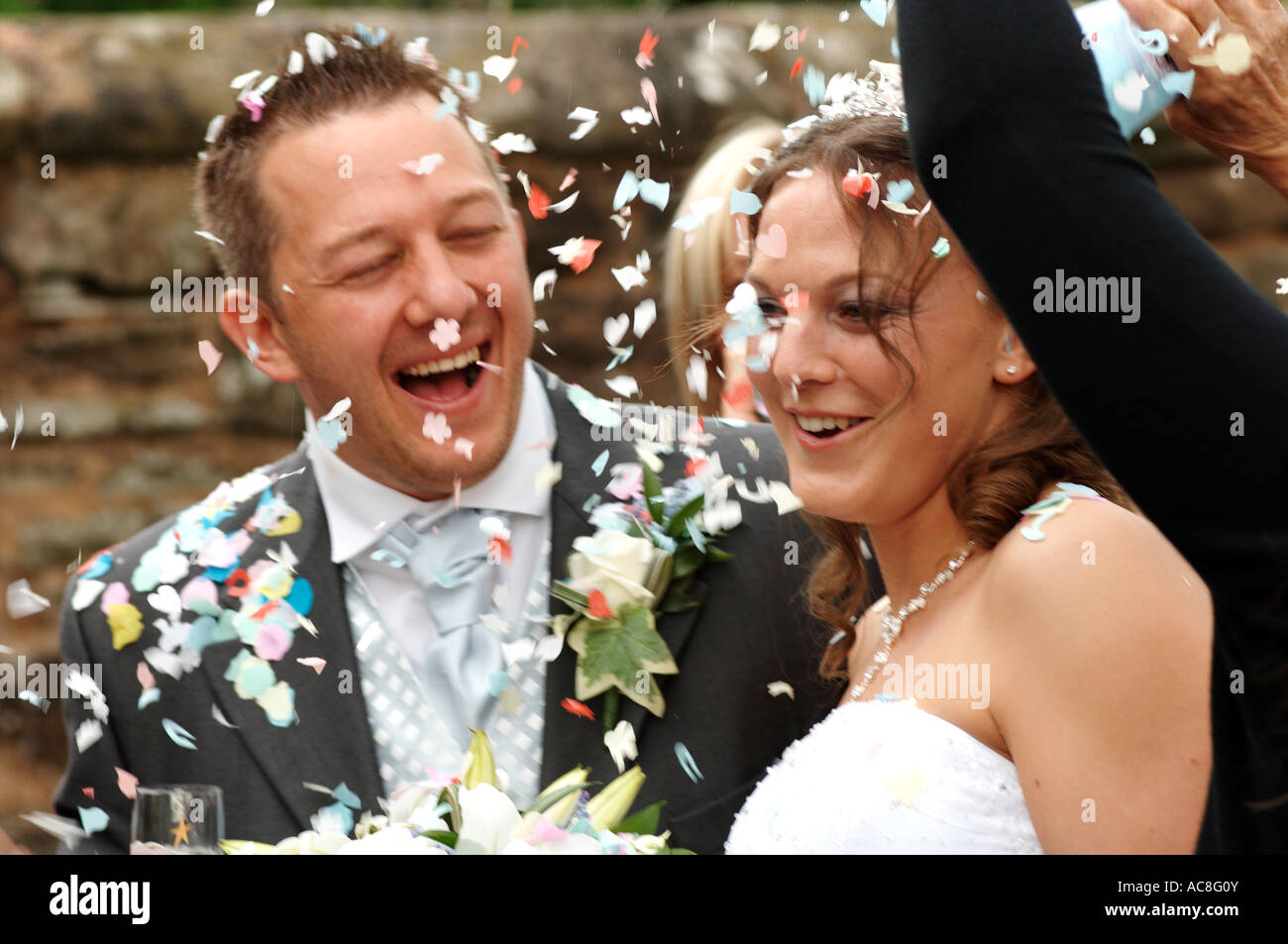 Bride and Groom with confetti being thrown over them Stock Photo - Alamy