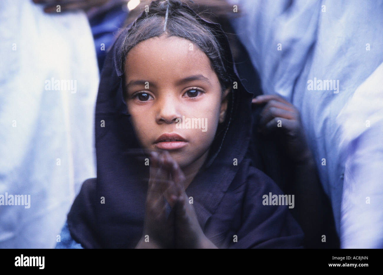 Tuareg girl in indigo robes, claps to the Tindé drum during the ...