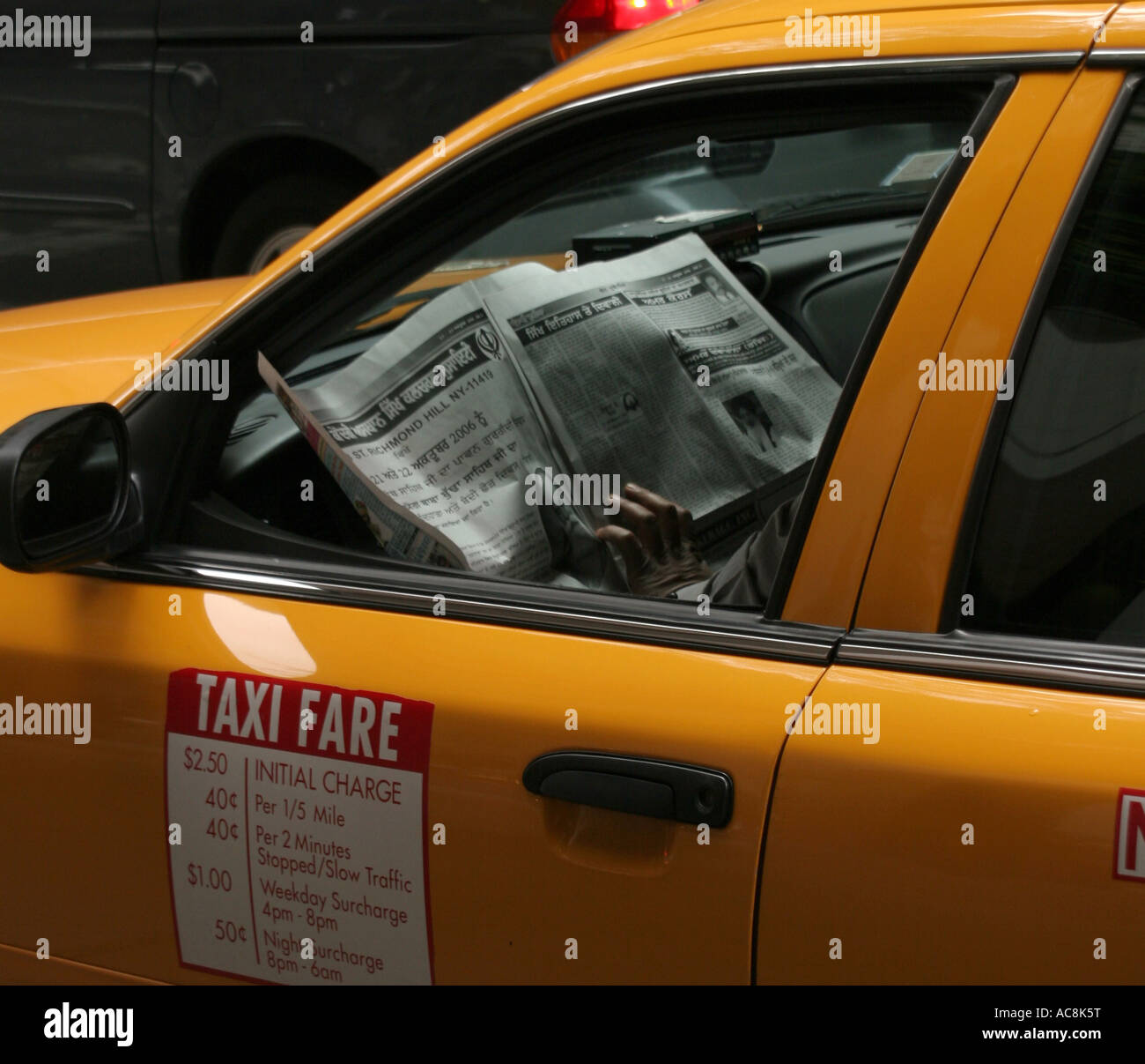 New York taxi driver reading Stock Photo - Alamy