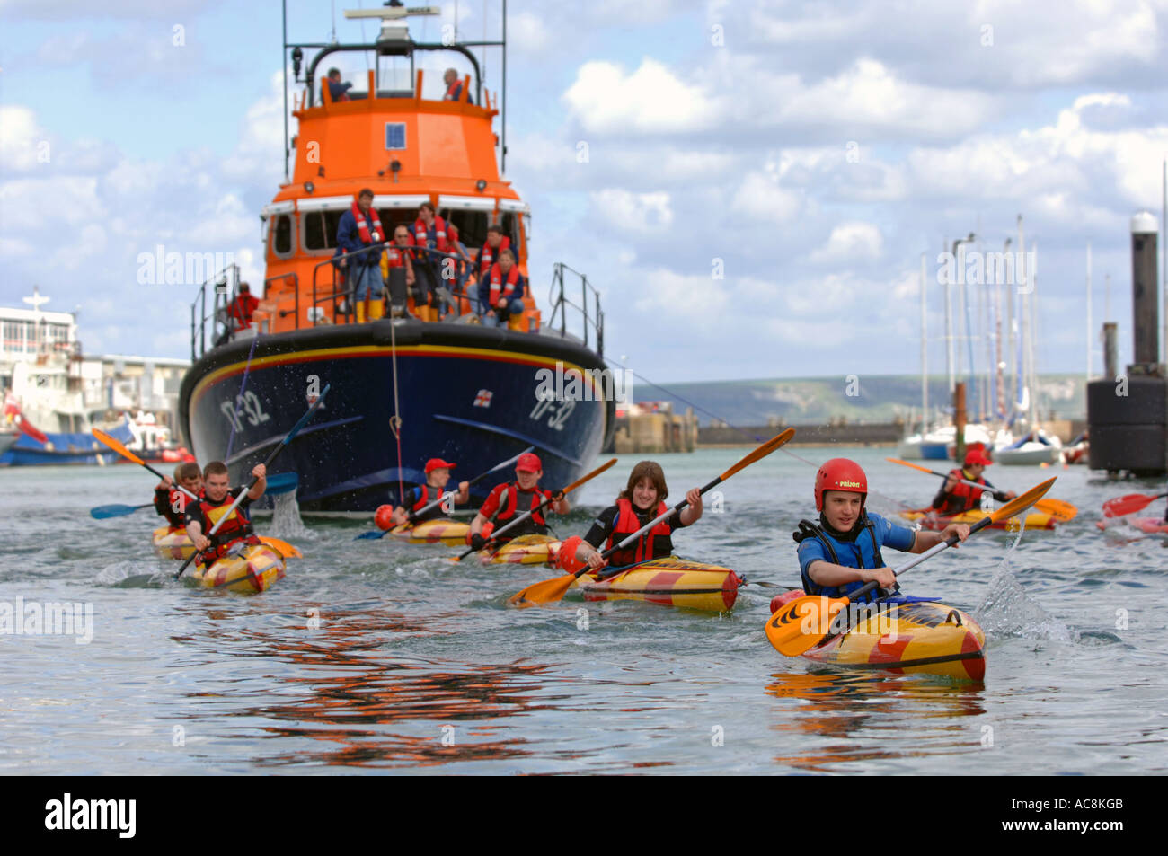 Canoeists pull Weymouth Lifeboat, Weymouth, Dorset Britain UK Stock ...