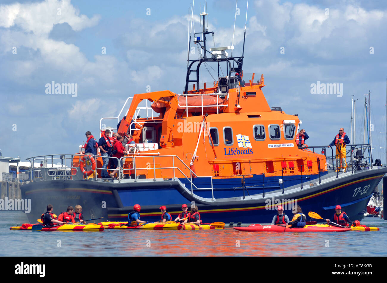 Canoeists pull Weymouth Lifeboat, Weymouth, Dorset Britain UK Stock ...