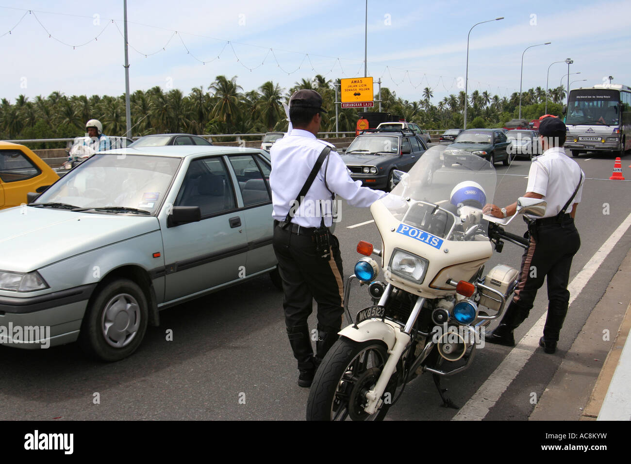 Malaysian highway police manning a road block on Sultan Mahmud Bridge ...