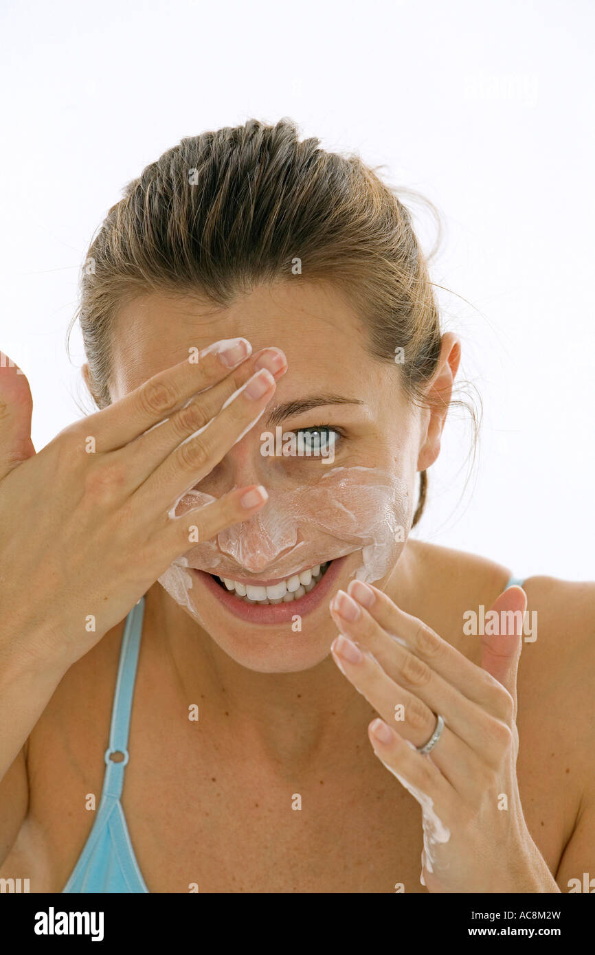 Portrait of a young woman applying soap to her face Stock Photo - Alamy