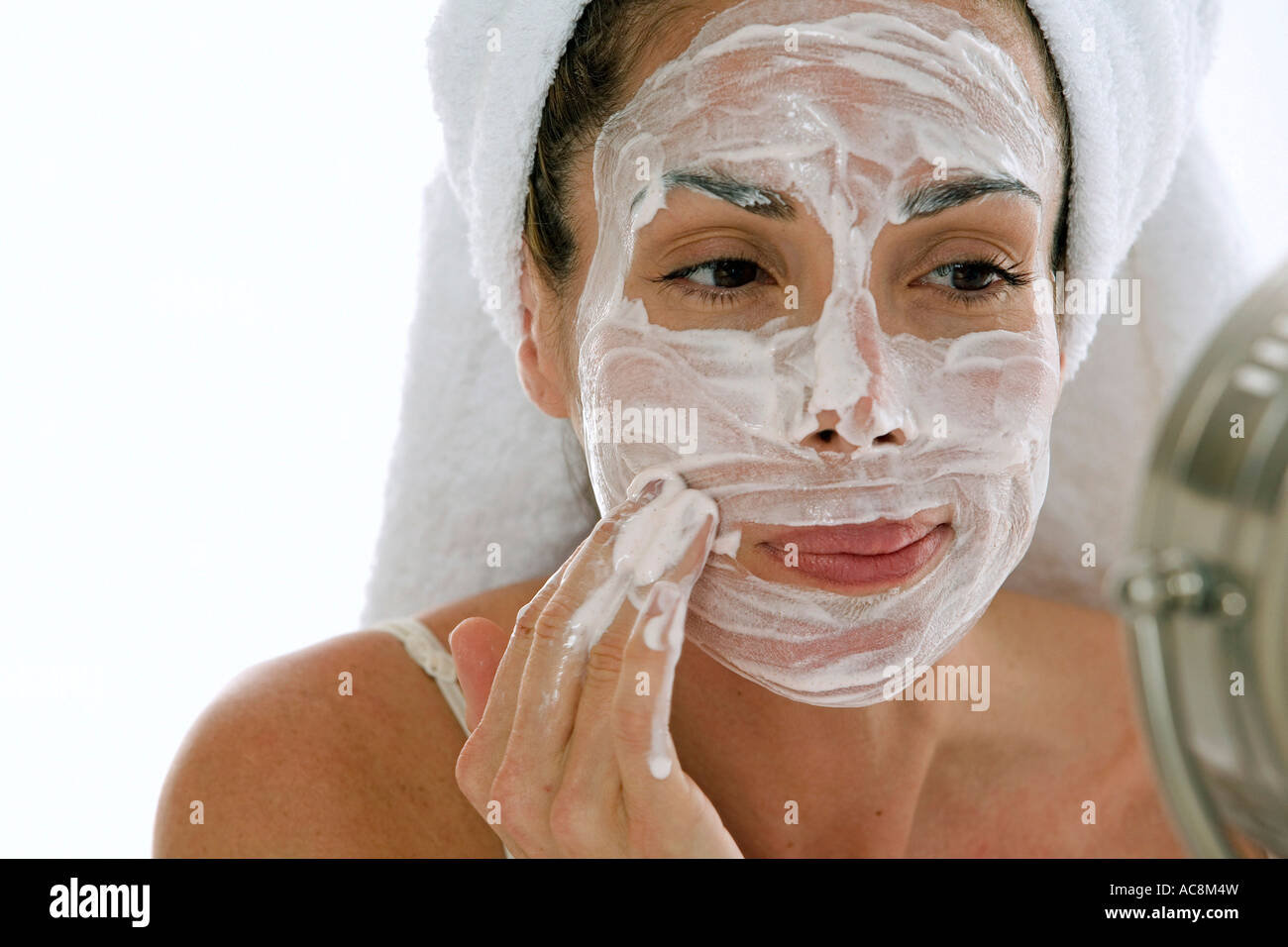 Close-up of a young adult woman applying cleanser to her face Stock ...